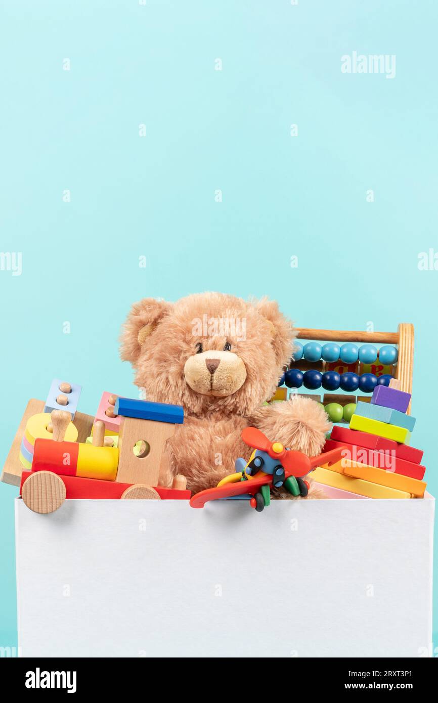 Toy box full of baby kid toys. Container with teddy bear, fluffy and ...