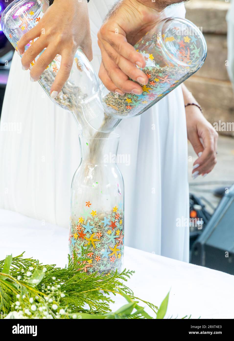 A couple pouring sand into a glass jar. Wedding ceremony Stock Photo ...