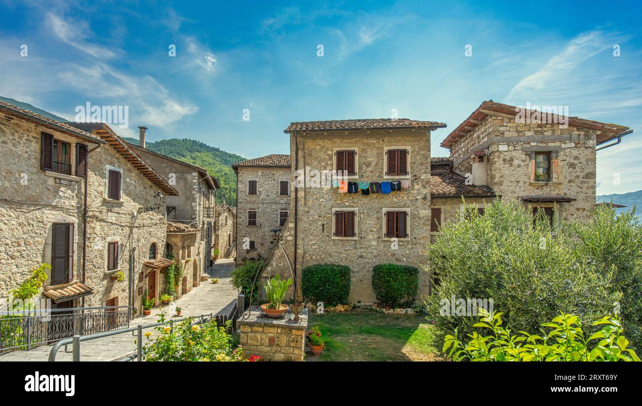 Old medieval houses made of travertine stone restored in Castel Trosino ...