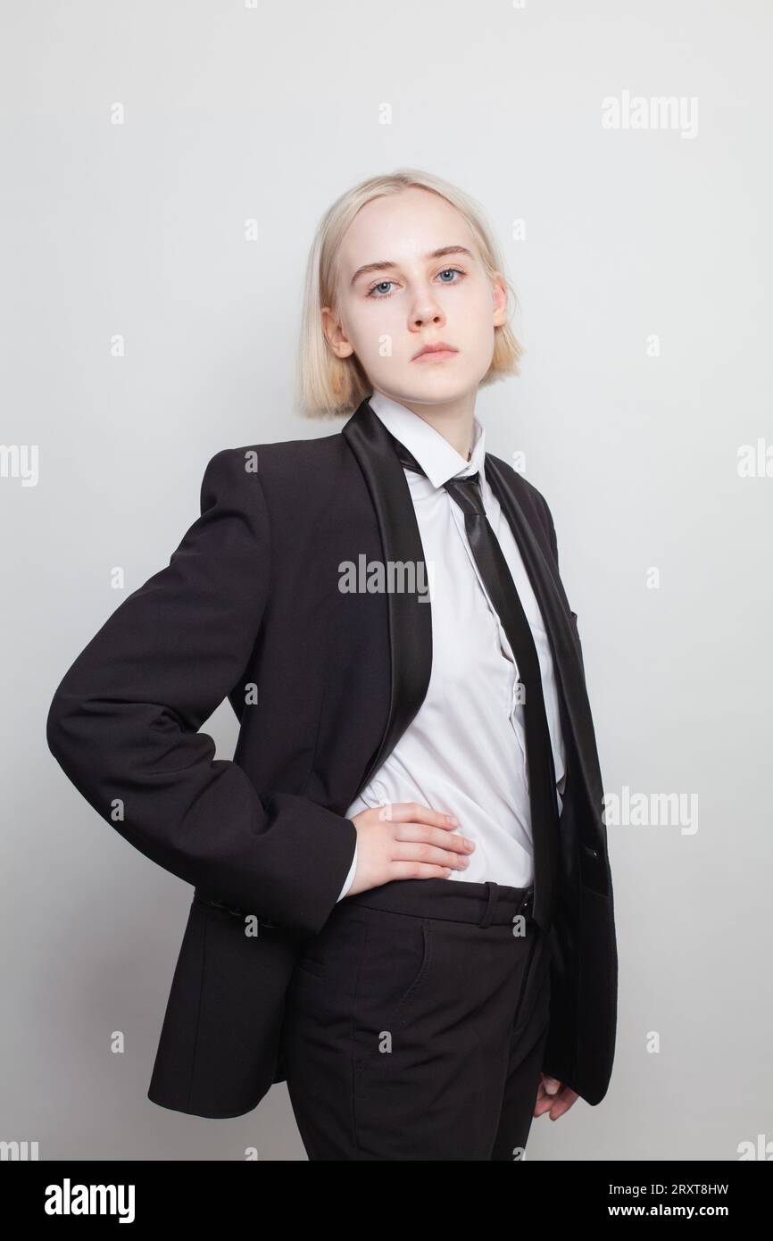 Attractive woman with blond bob hairstyle poses in a men's suit ...