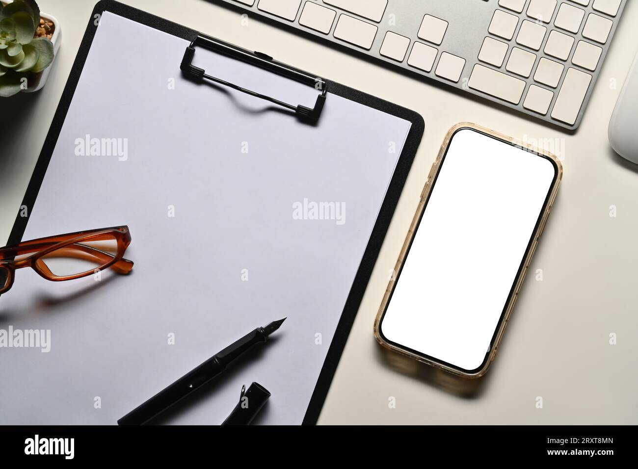 Smartphone with blank screen, clipboard and glasses on white office ...