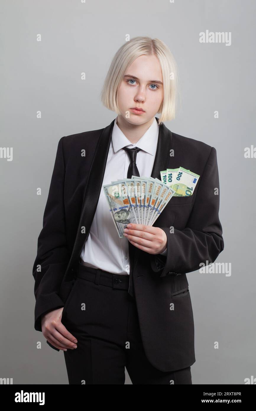 Attractive serious successful businesswoman holding money cash US ...