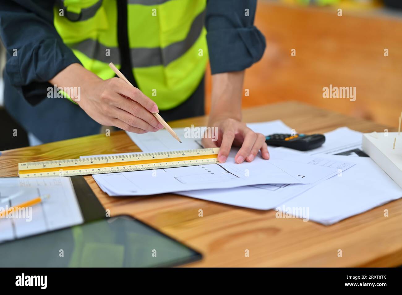 Cropped shot of architect reviewing blueprints working on sketch of a ...