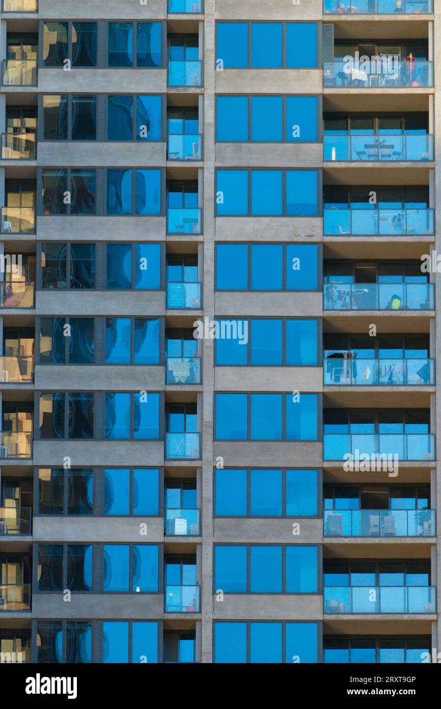 Modern city building apartment block with balconies, windows and glass ...