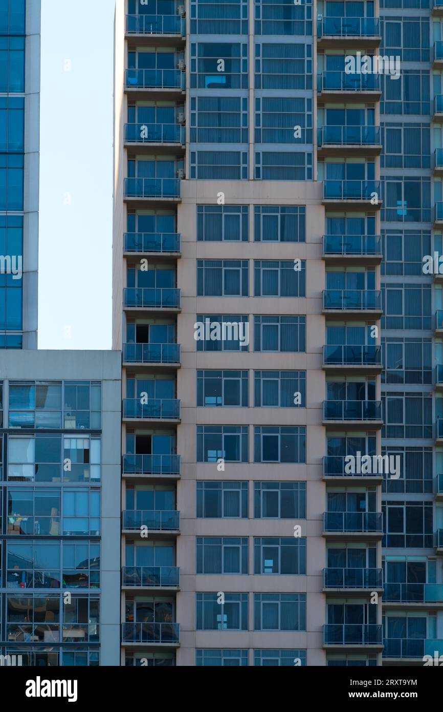 Modern city building apartment block with small balconies, glass ...