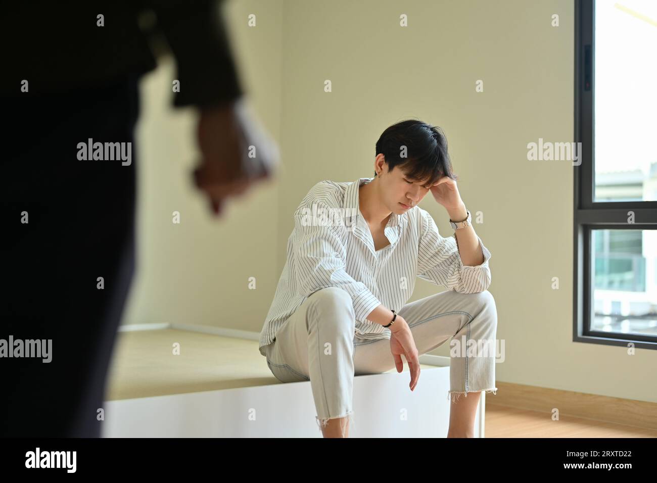 Man clenching fist in anger with crying man in background. LGBTQ ...