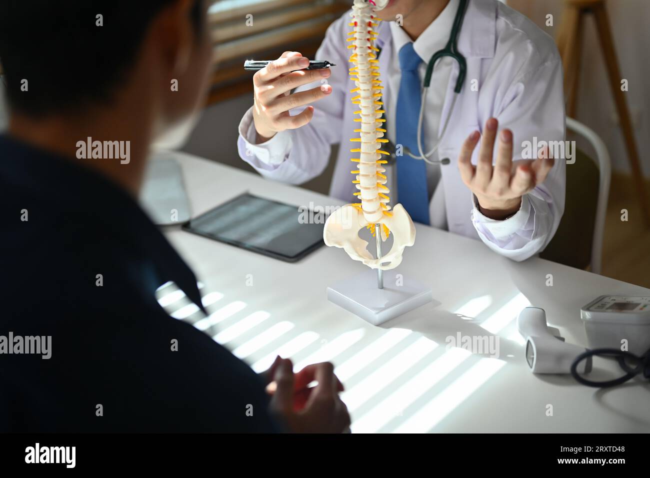 Orthopedist giving consultation about scoliosis or spinal problems to ...