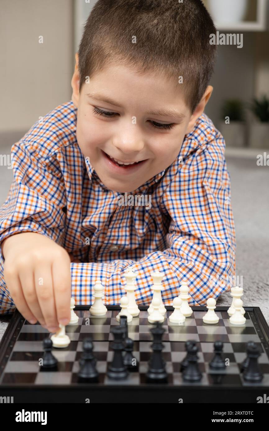 Little boy playing chess. Board games for children Stock Photo - Alamy