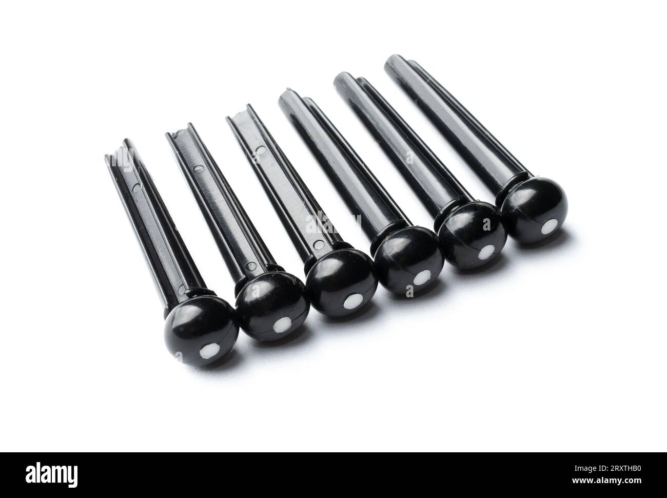 Set of six acoustic guitar black bridge pins Stock Photo - Alamy