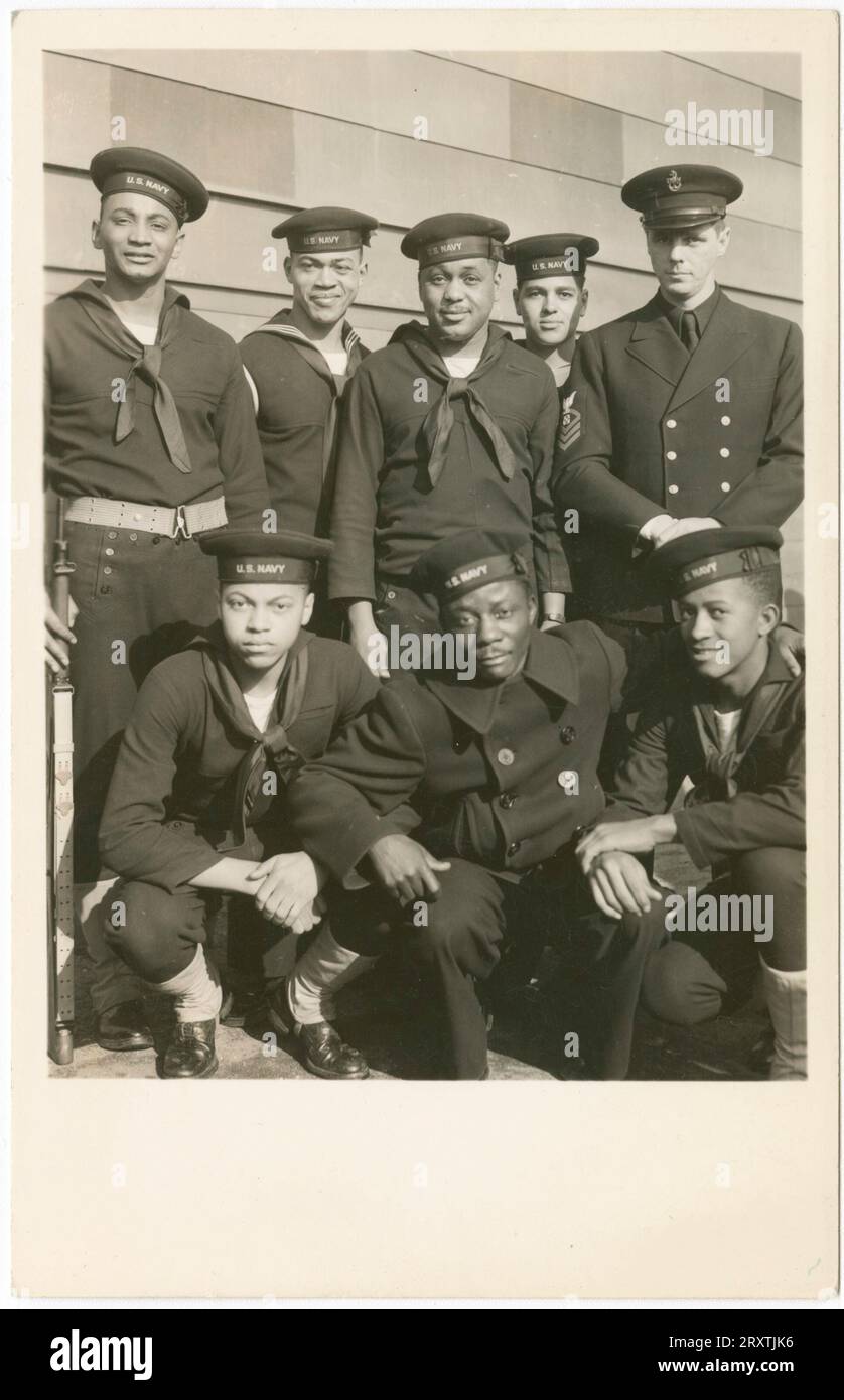 A black-and-white photographic postcard of eight members of the U.S ...
