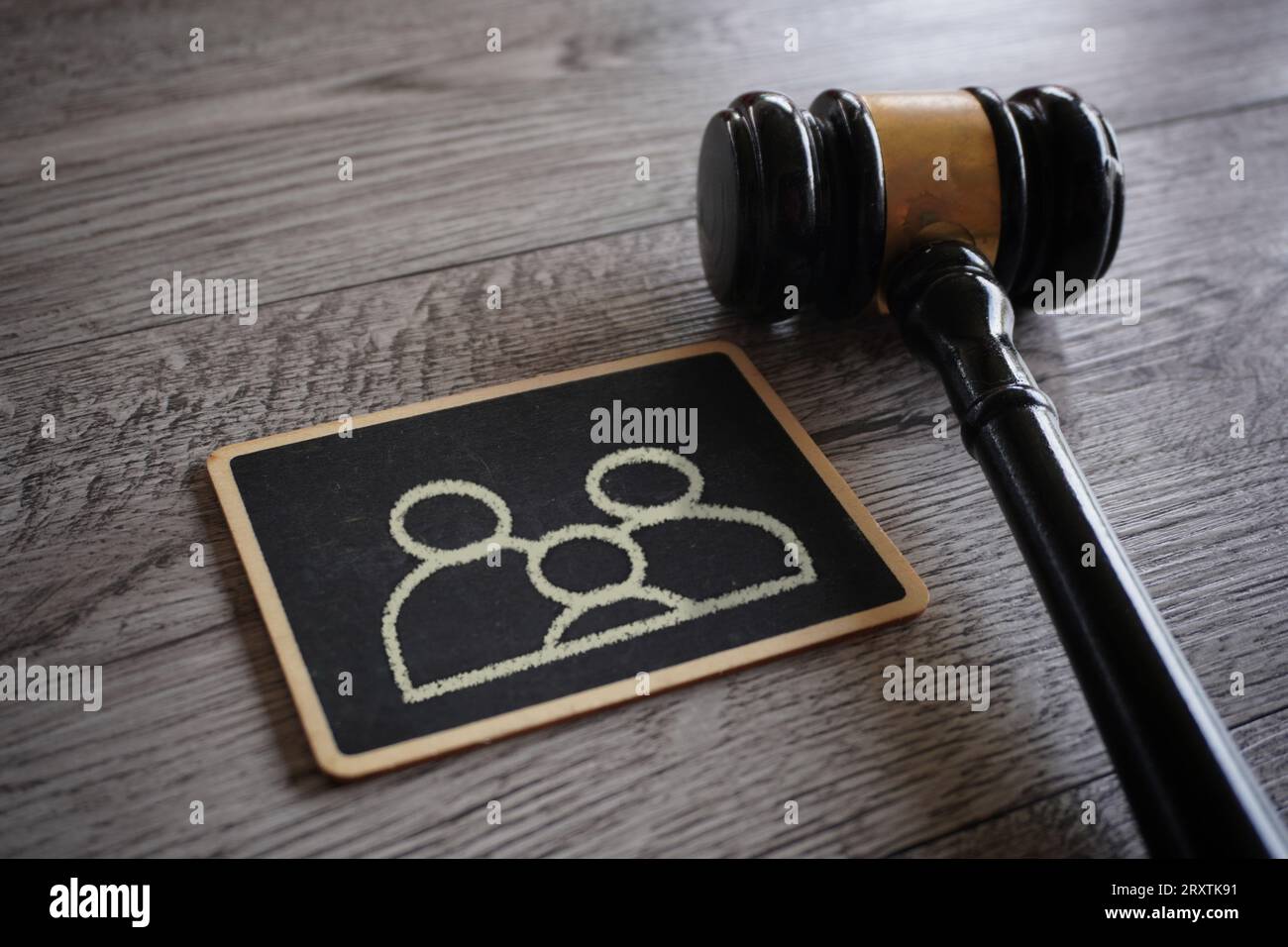 Closeup image judge gavel and chalkboard with family icon. Guardianship, family law concept ...