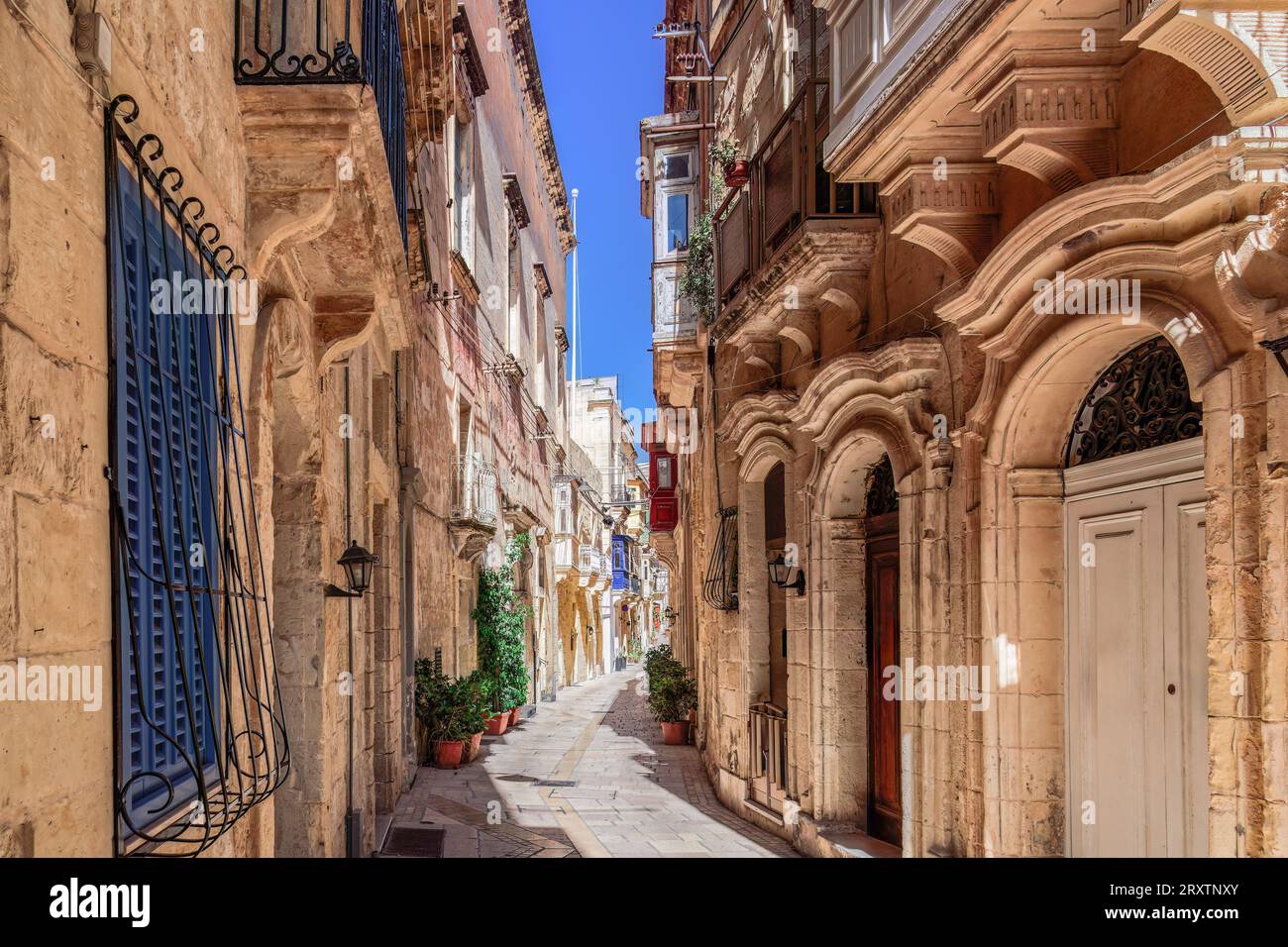 Traditional Maltese limestone buildings with coloured balconies in the ...