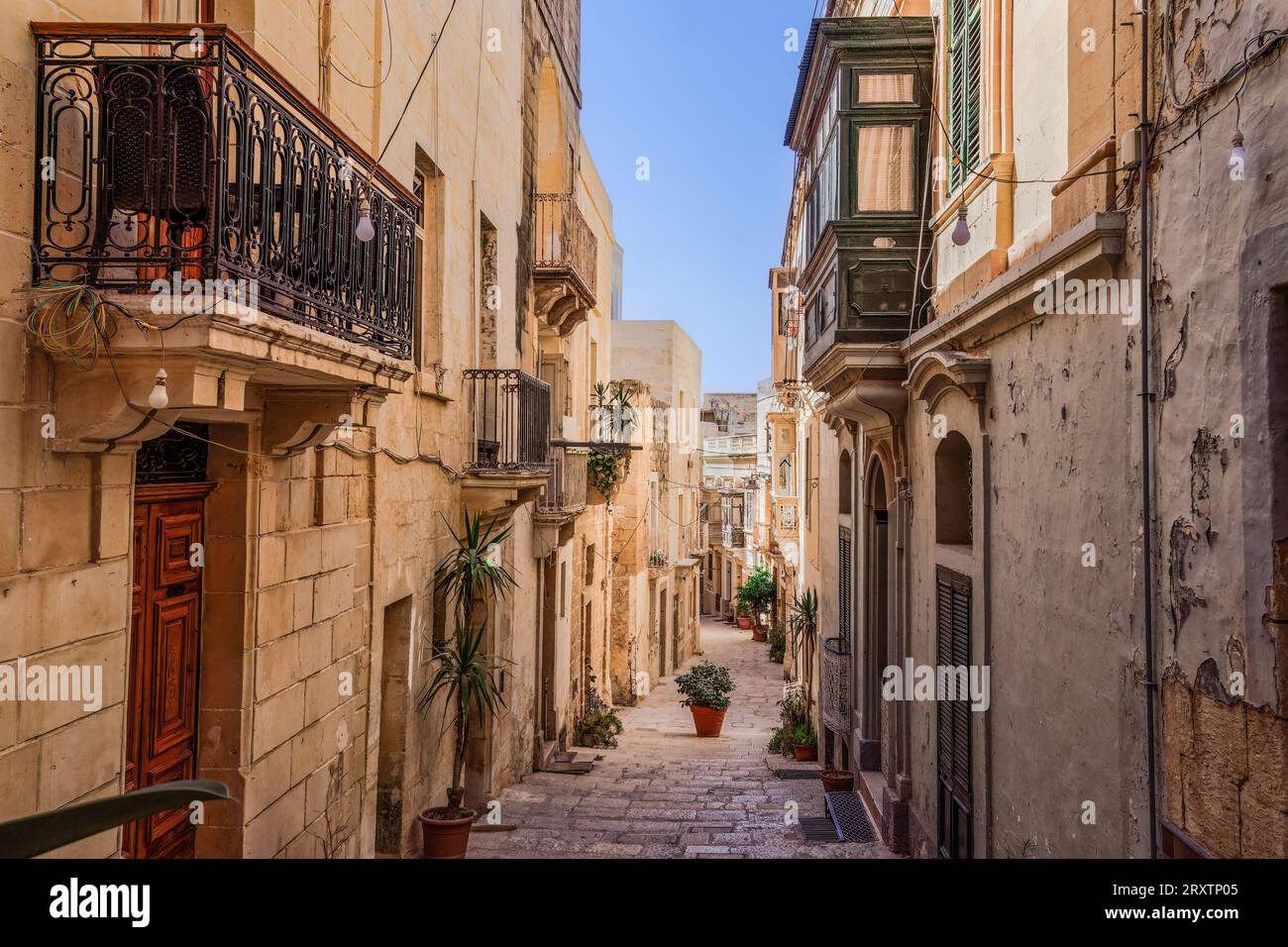 Traditional Maltese limestone buildings with coloured balconies in the ...