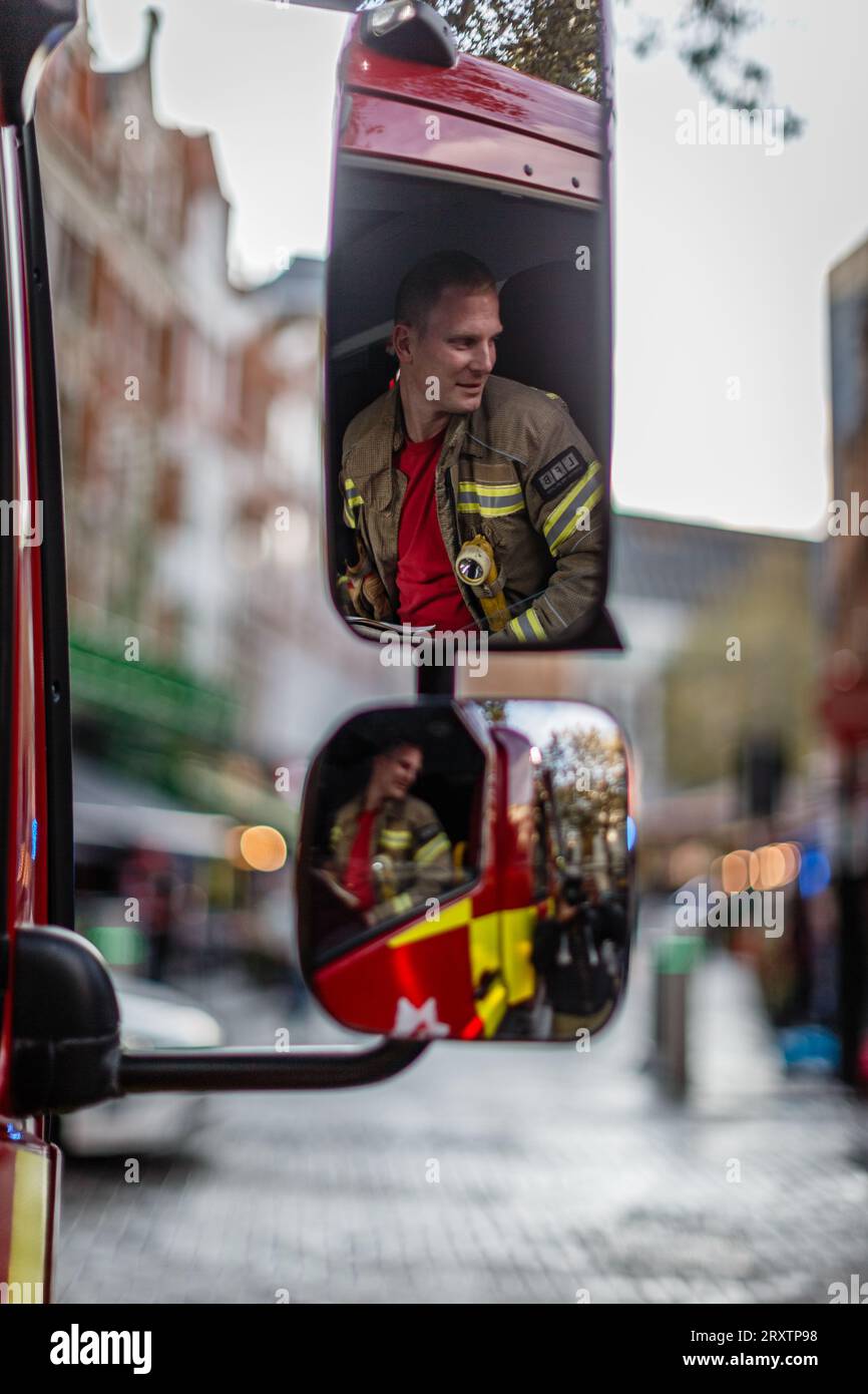 Firefighter in the mirror at the scene of an incident in London Stock ...