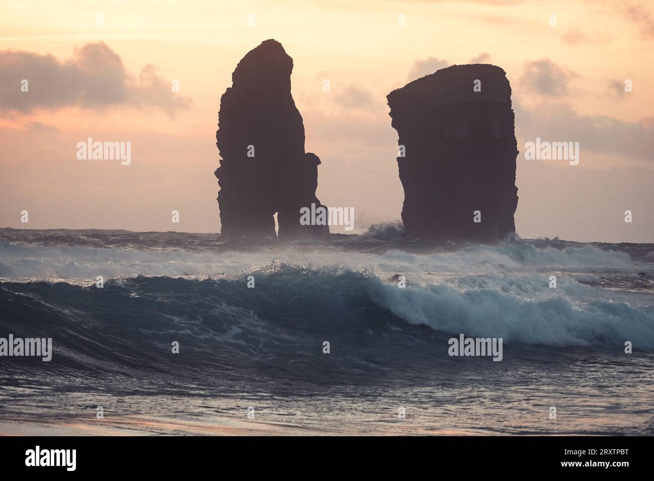 The sea stacks of Mosteiros at sunset with high waves in the foreground ...