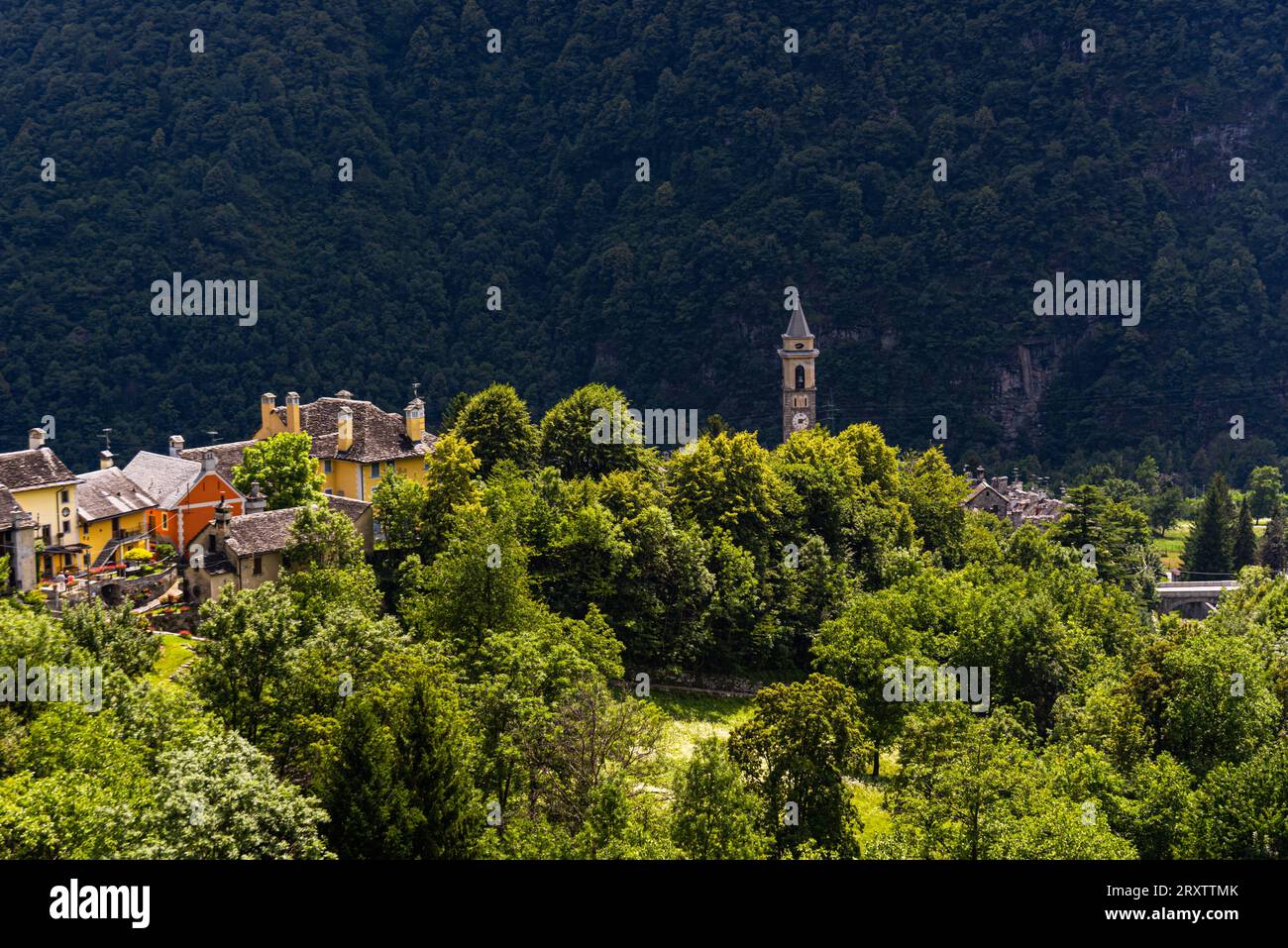 The township of Varzo viewed from a distance wth roof tops and spire ...