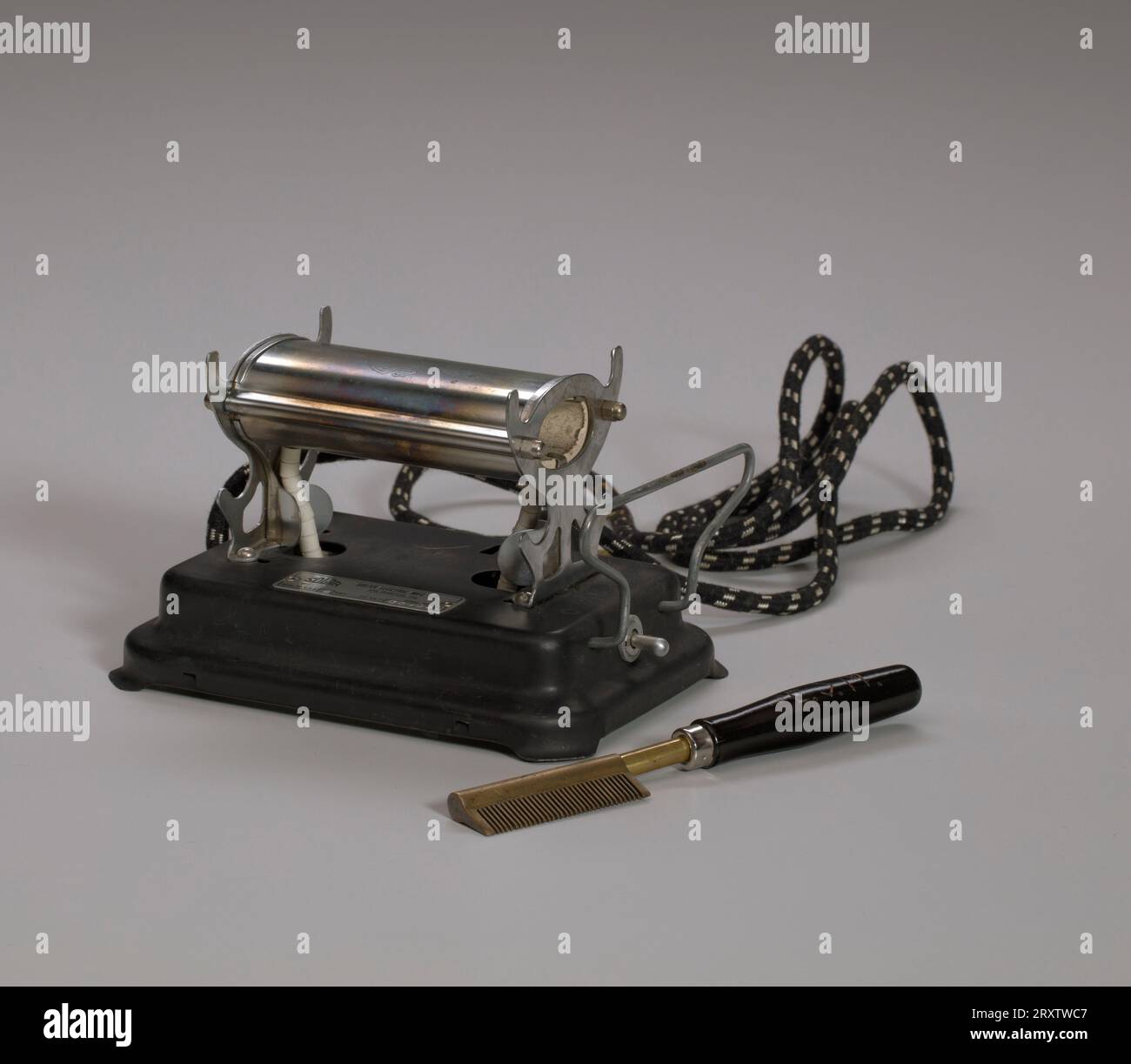 Electrical hot comb heater and hot comb 1920s Stock Photo - Alamy