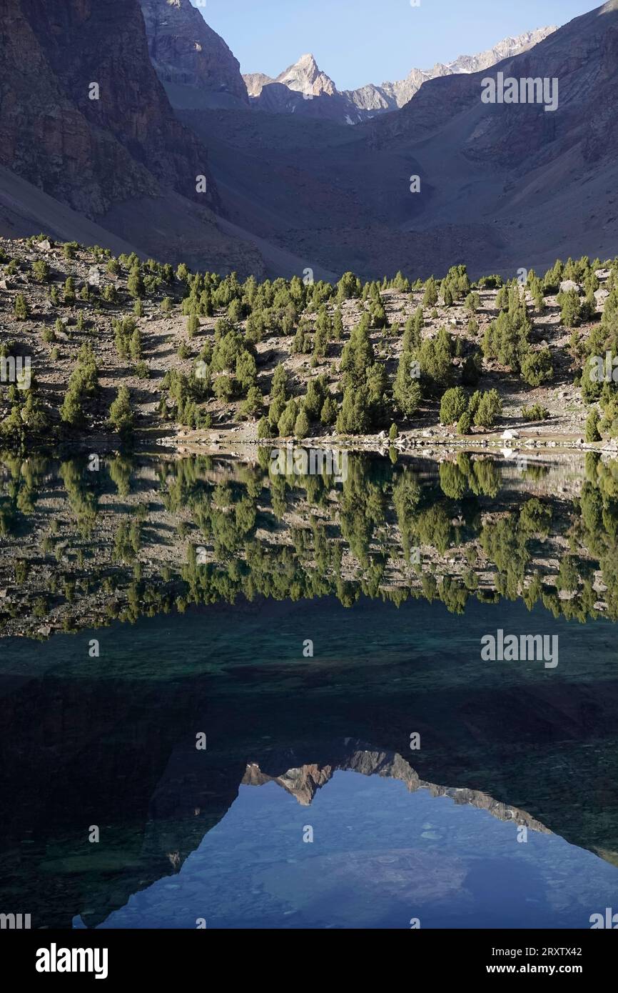 Reflections in a lake in the remote and spectacular Fann Mountains ...
