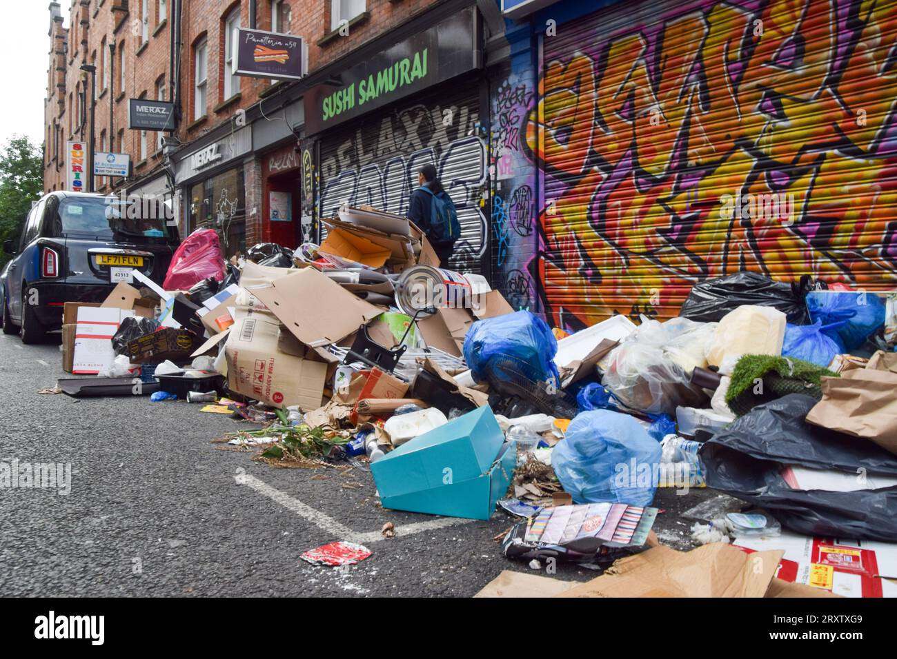 September 27, 2023, London, England, UK: Huge piles of garbage line the streets near Brick Lane ...