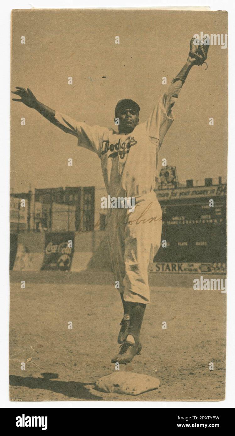 A photograph of Jackie Robinson in a Dodgers uniform. He is leaping ...