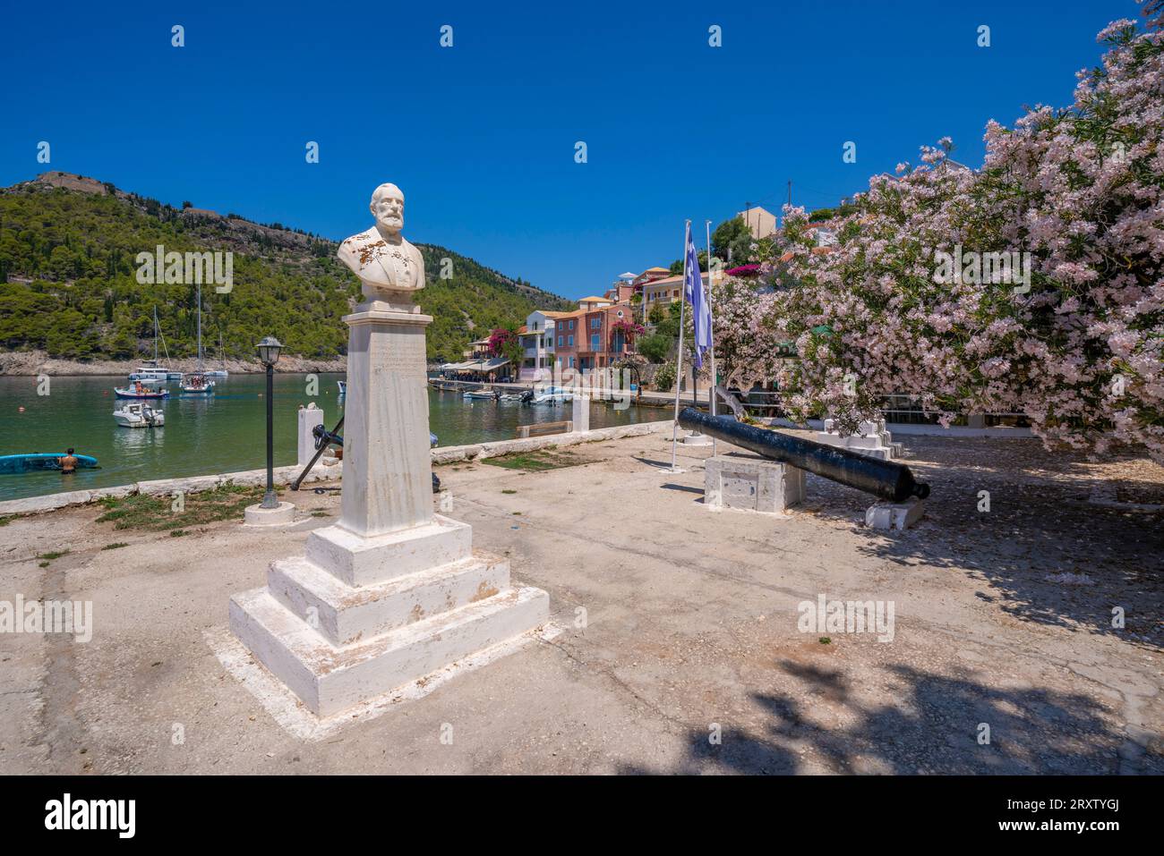 View of statue and colourful houses in Assos, Assos, Kefalonia, Ionian ...