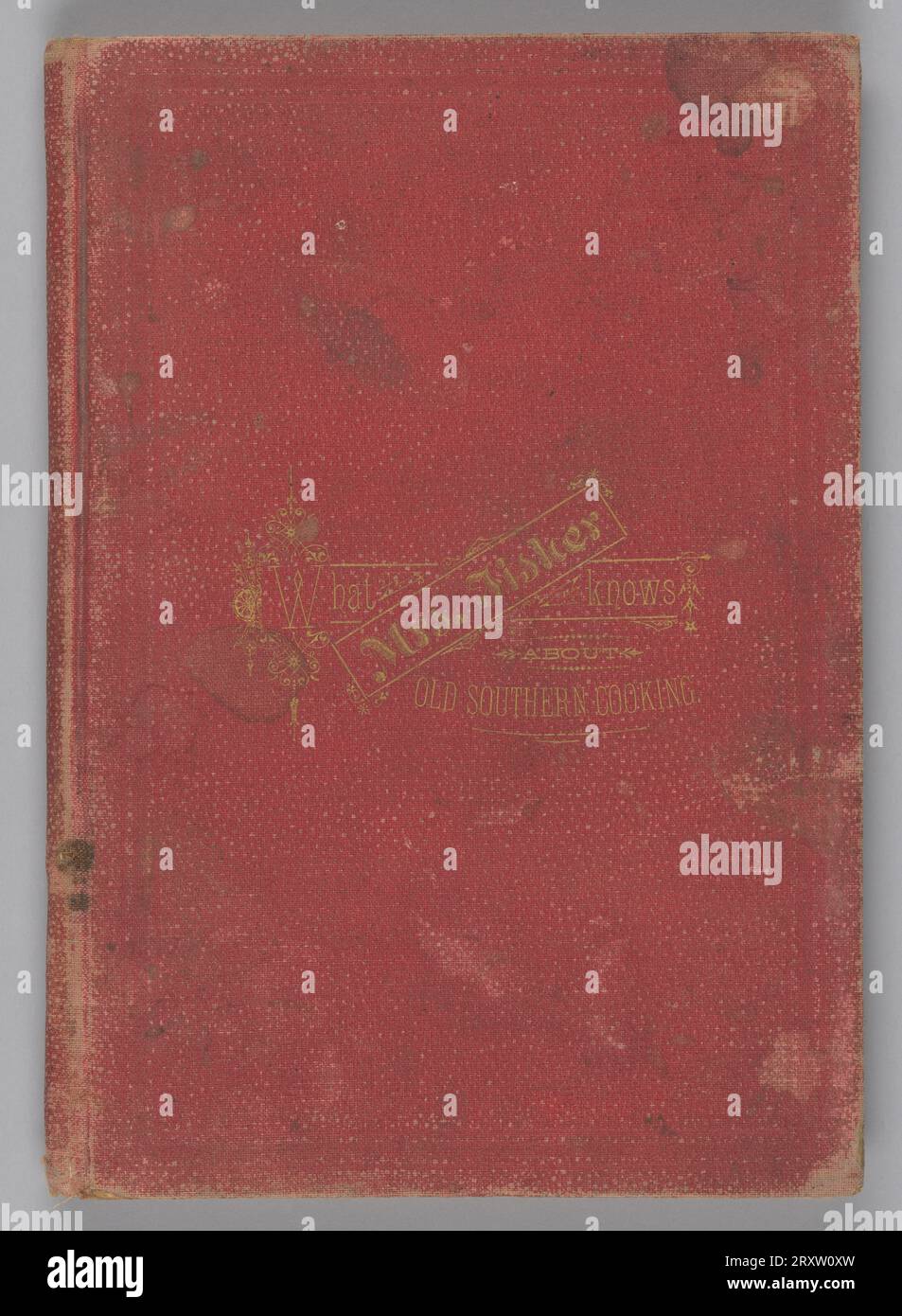This is a small hardcopy book with a red cloth cover. On the front in ...