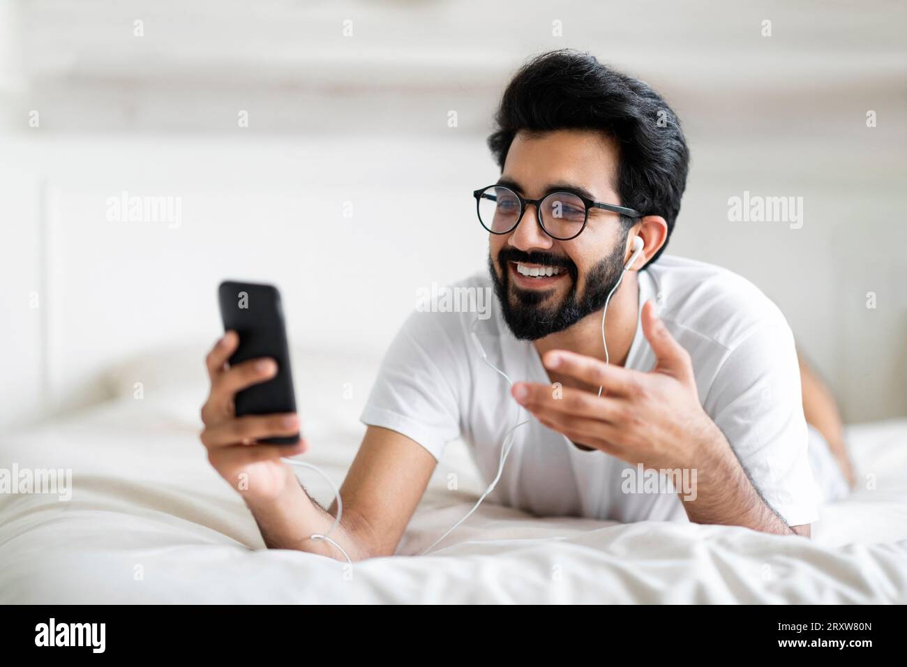 Indian man smartphone in bed hi-res stock photography and images - Alamy