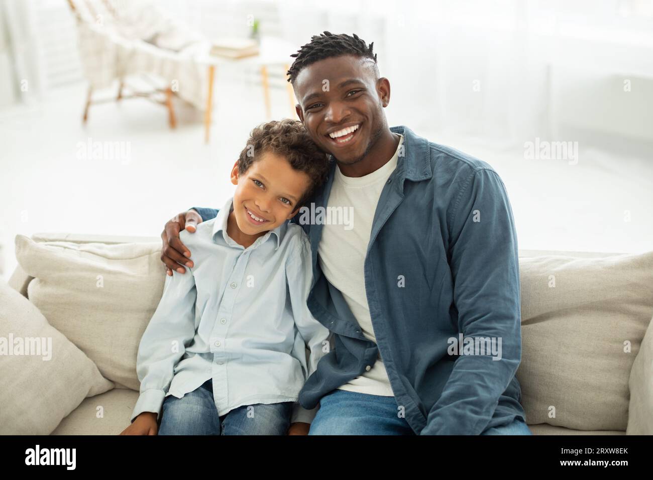 Happy Black Dad And Son Hugging Posing Together At Home Stock Photo - Alamy