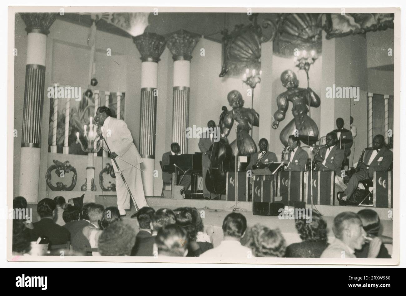 B & W photograph of Cab Calloway performing on stage in front of his ...