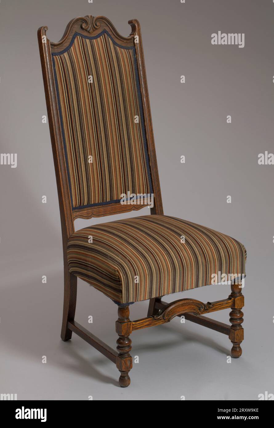 High-backed wooden side chair with an upholstered seat and back. The ...