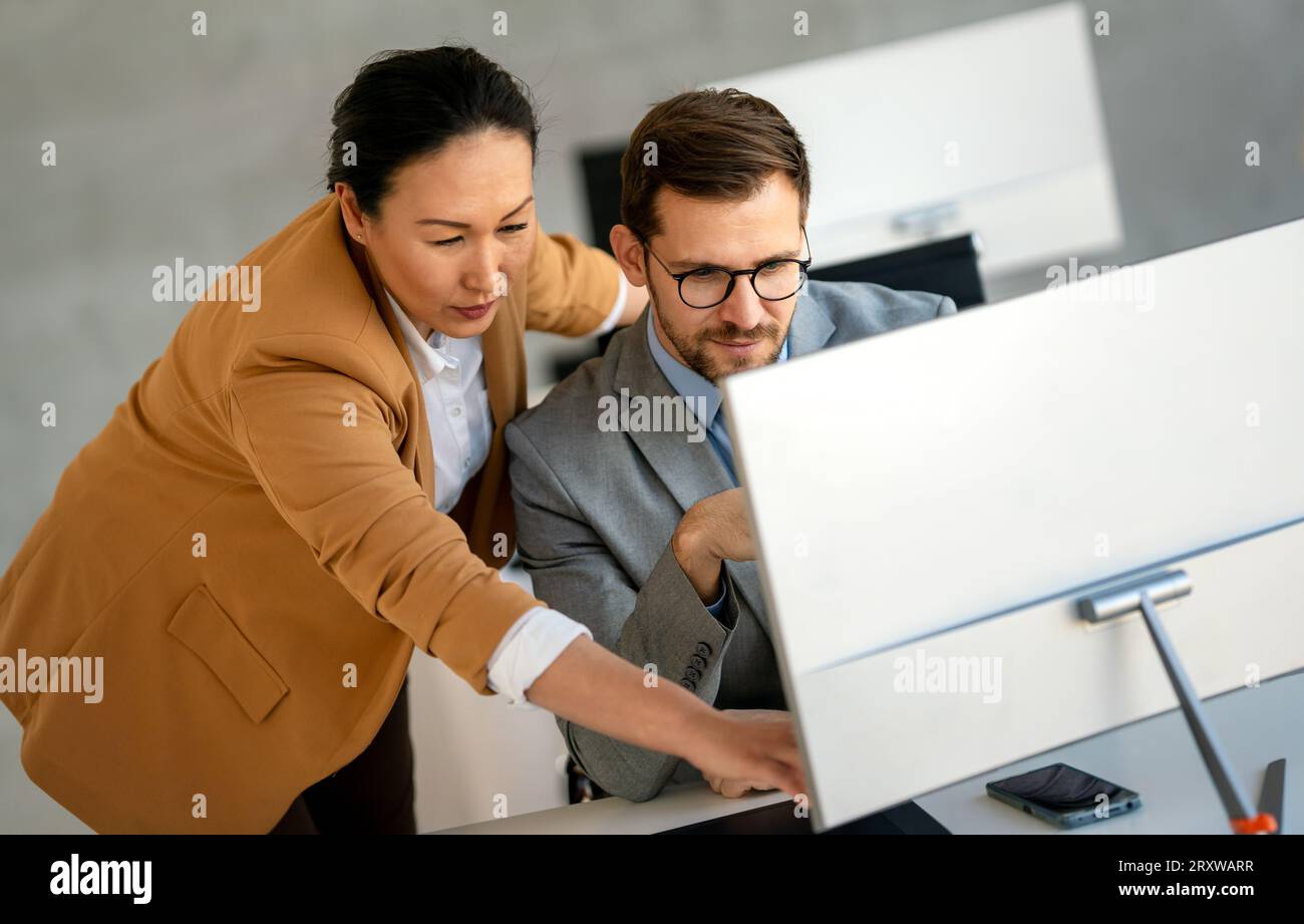 Business men with colleague traders at office monitoring stocks data on ...