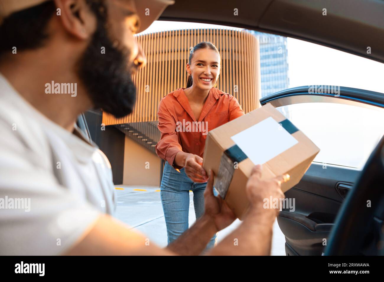 Courier Man Handing Delivered Parcel Box To Client From Car Stock Photo ...