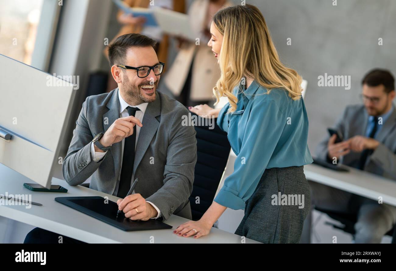 Portrait of successful business people working, talking together in ...