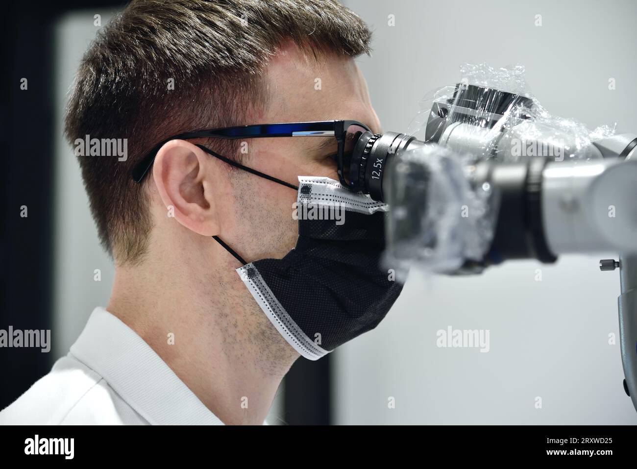 dentist using dental microscope in clinic Stock Photo - Alamy