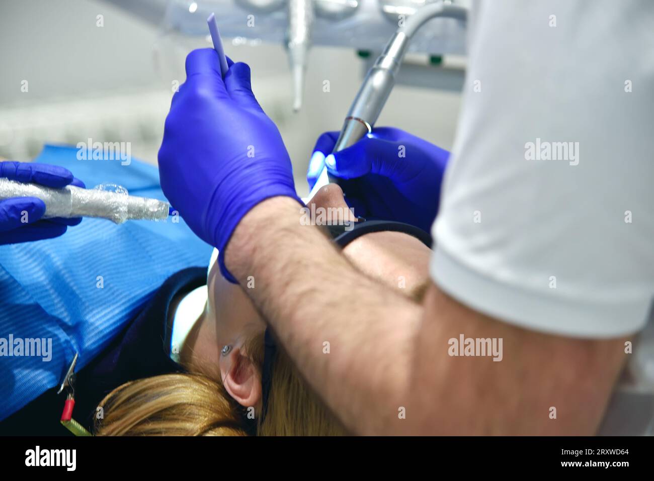 Dentist Treating Woman Patient. Treating Patient In Modern Dental ...