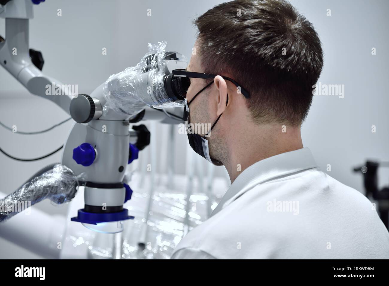 Dentist Using Dental Microscope In Modern Office. Medical Technology ...