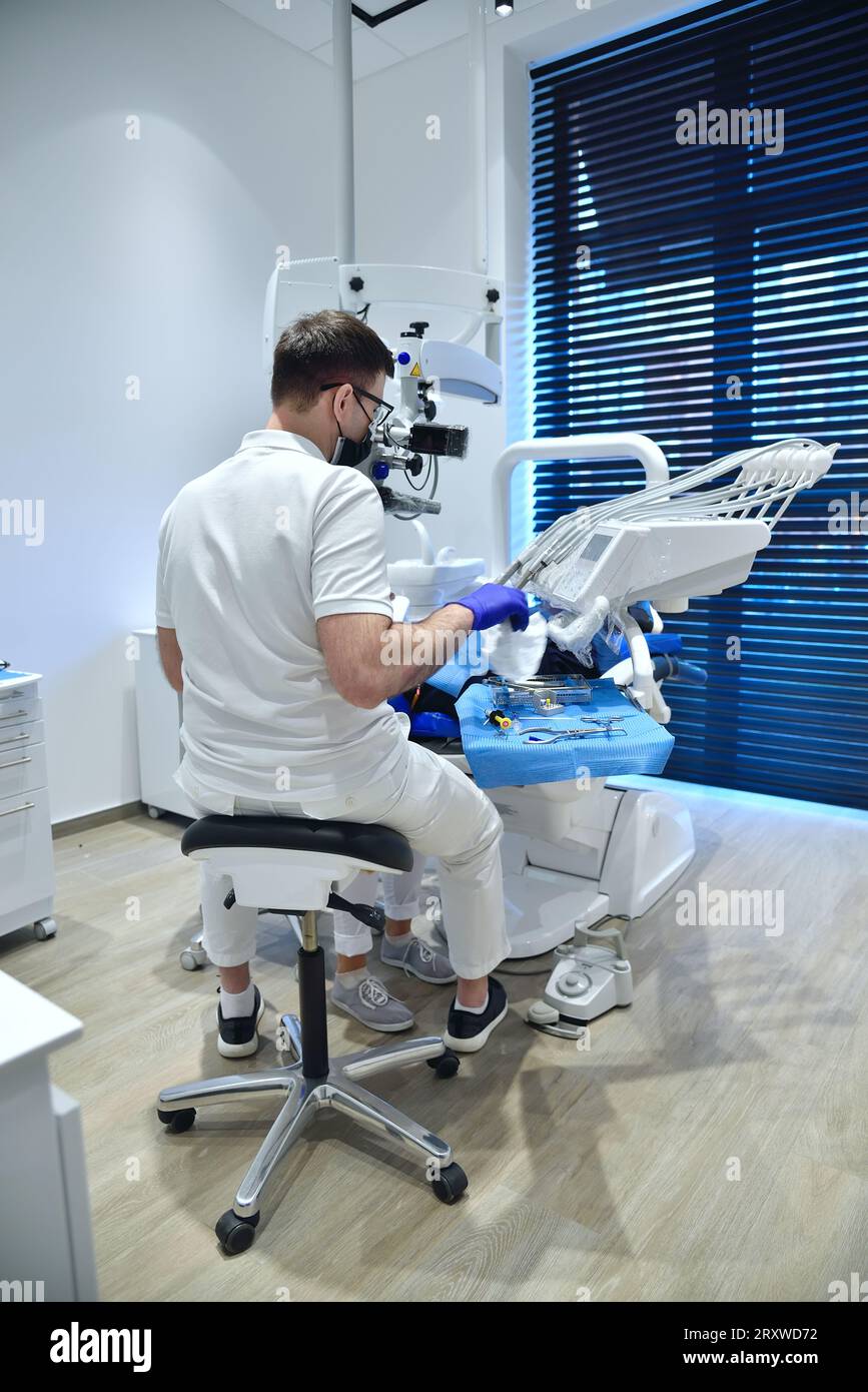 Dentist Surgeon In Uniform And Nurse Performing Operation Install ...
