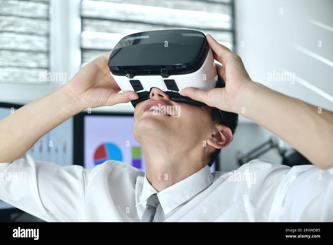 Stock Trader Man Wearing Virtual Reality Googles. Looking Around On ... Stock Trader Man Wearing Virtual Reality Googles. Looking Around On ...