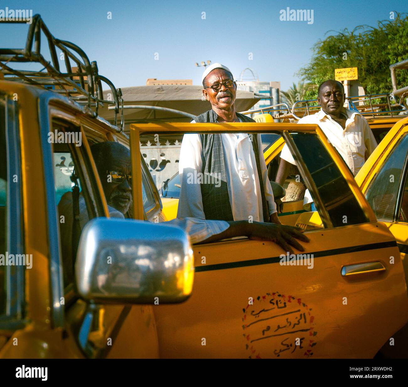 Picture of an old taxi driver with his taxi Stock Photo - Alamy