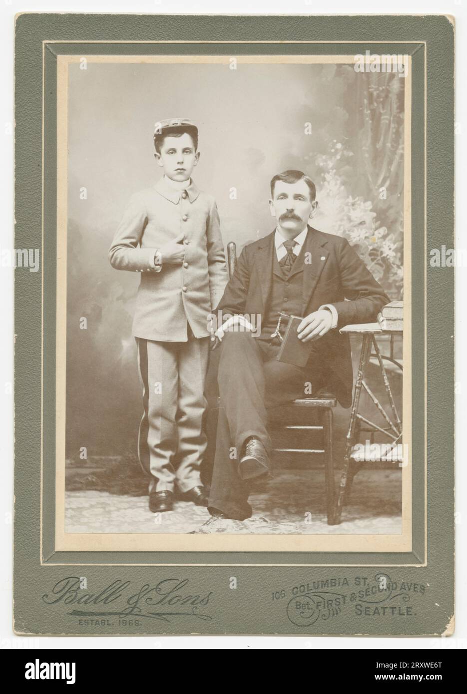 A black-and-white photograph of a man and young boy photographed at the ...