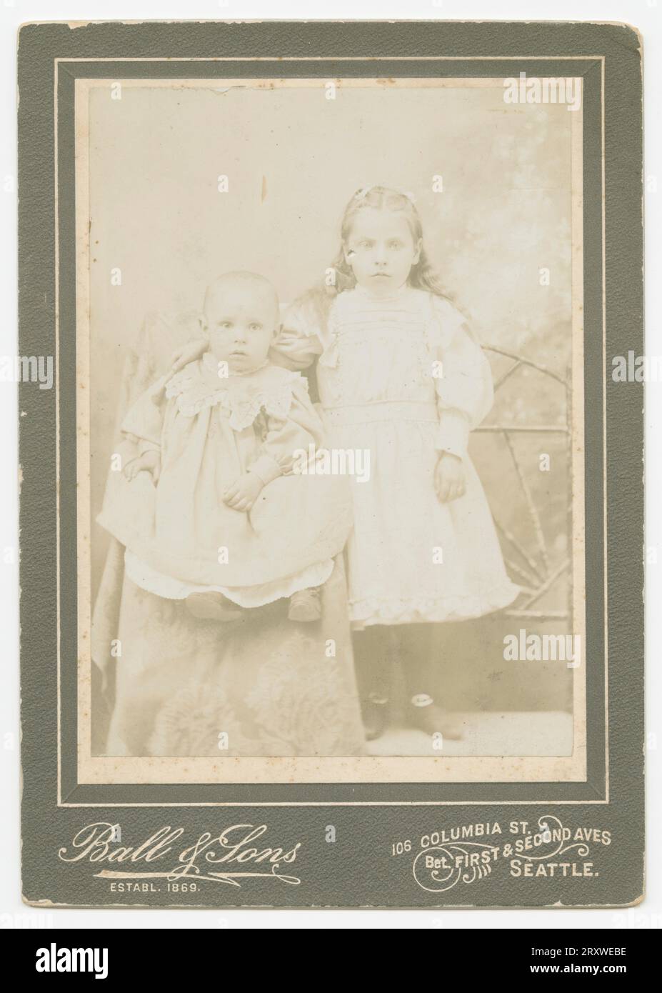 A black-and-white photograph of two small children photographed at the ...