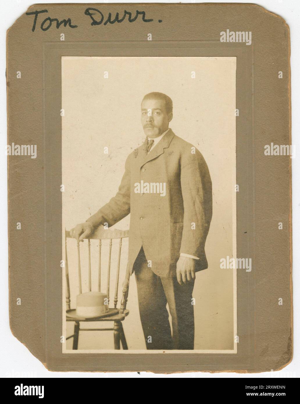 Photograph of Tom Durr standing next to a chair with a hat on it Stock ...