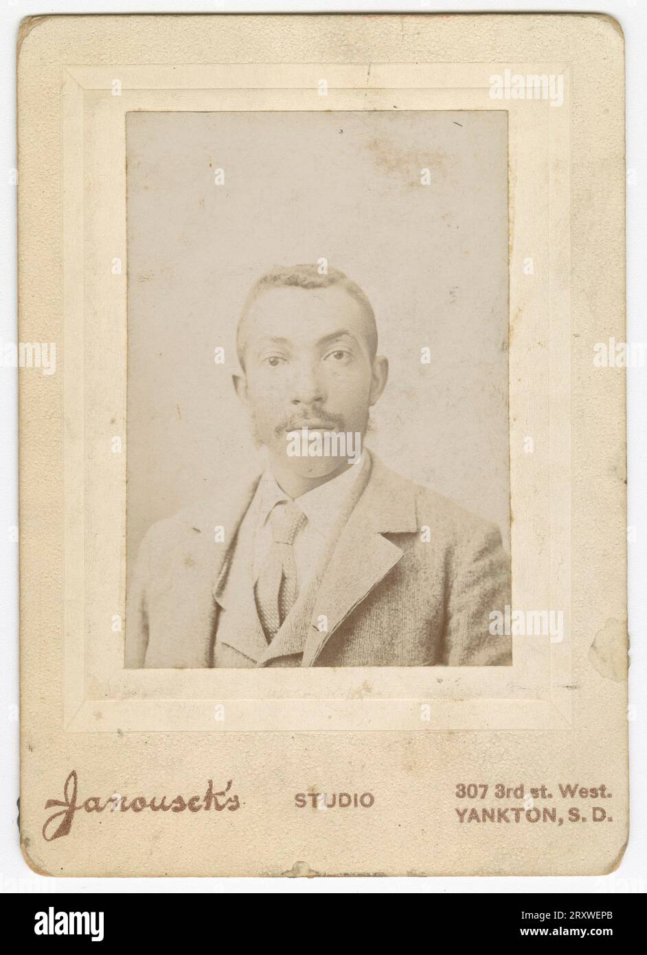 Photograph of a man wearing a light colored jacket, vest and necktie ...