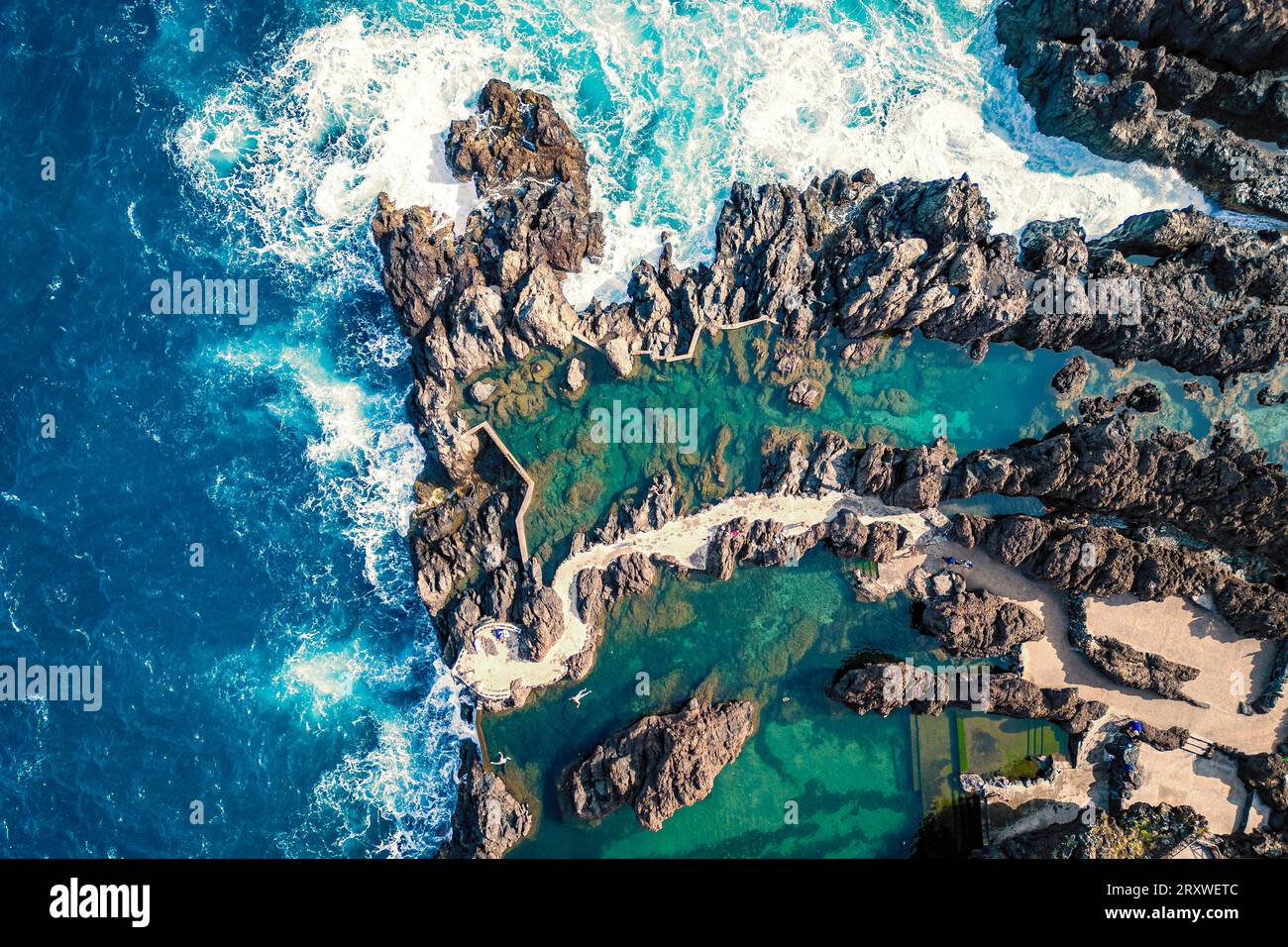 Fantastic bird's eye view of people swimming in the natural lava pools ...