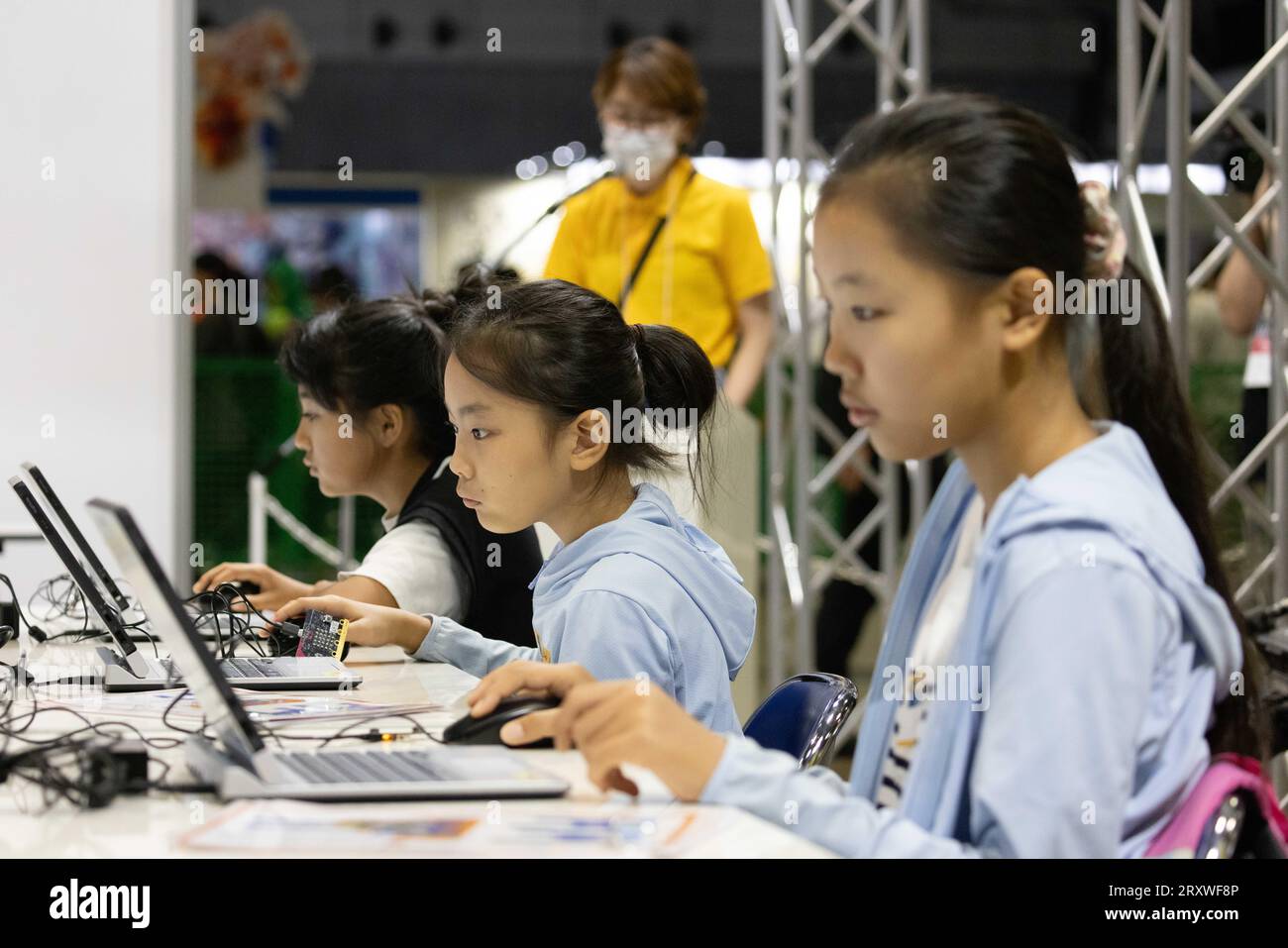 Participants of a video game programming workshop for kids solve an assigned programming task on ...
