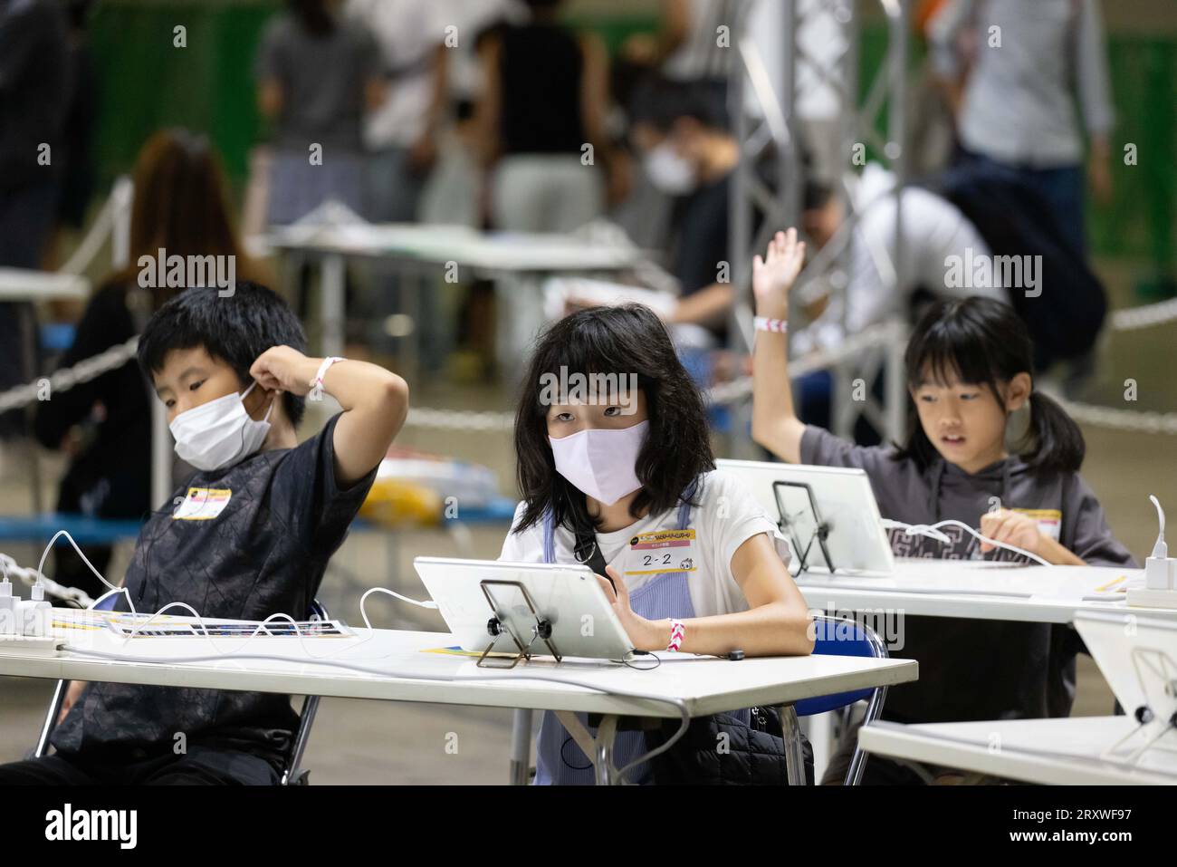 Participants of a video game programming workshop for kids listen to ...