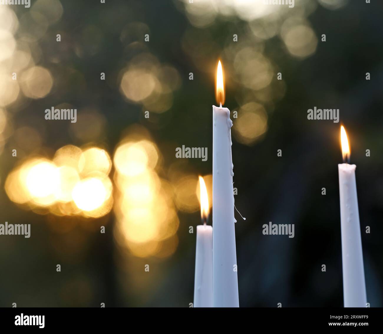 Three white burning candles hi-res stock photography and images - Alamy