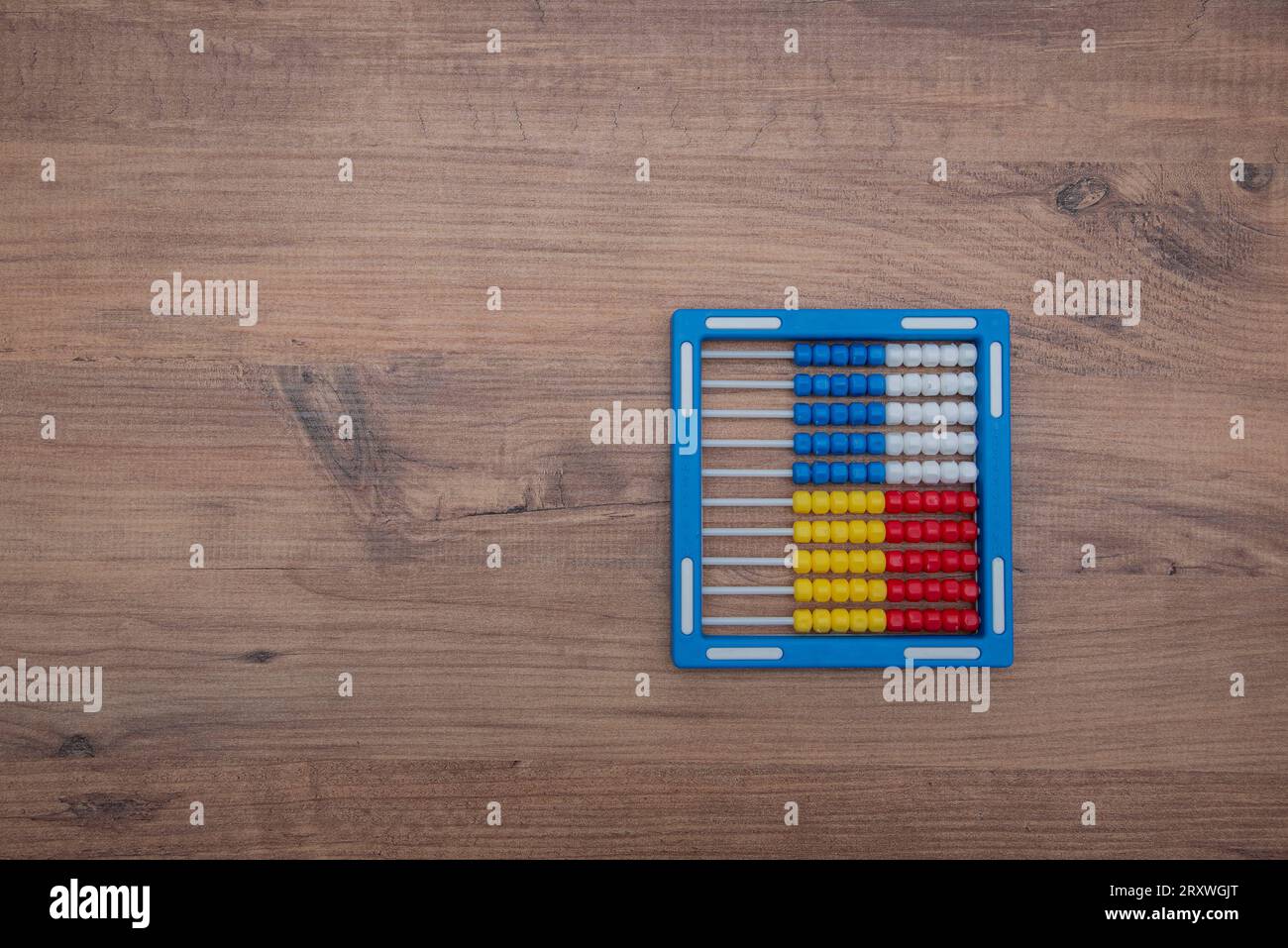 Childrens plastic abacus of blue color on a wooden surface. top view ...