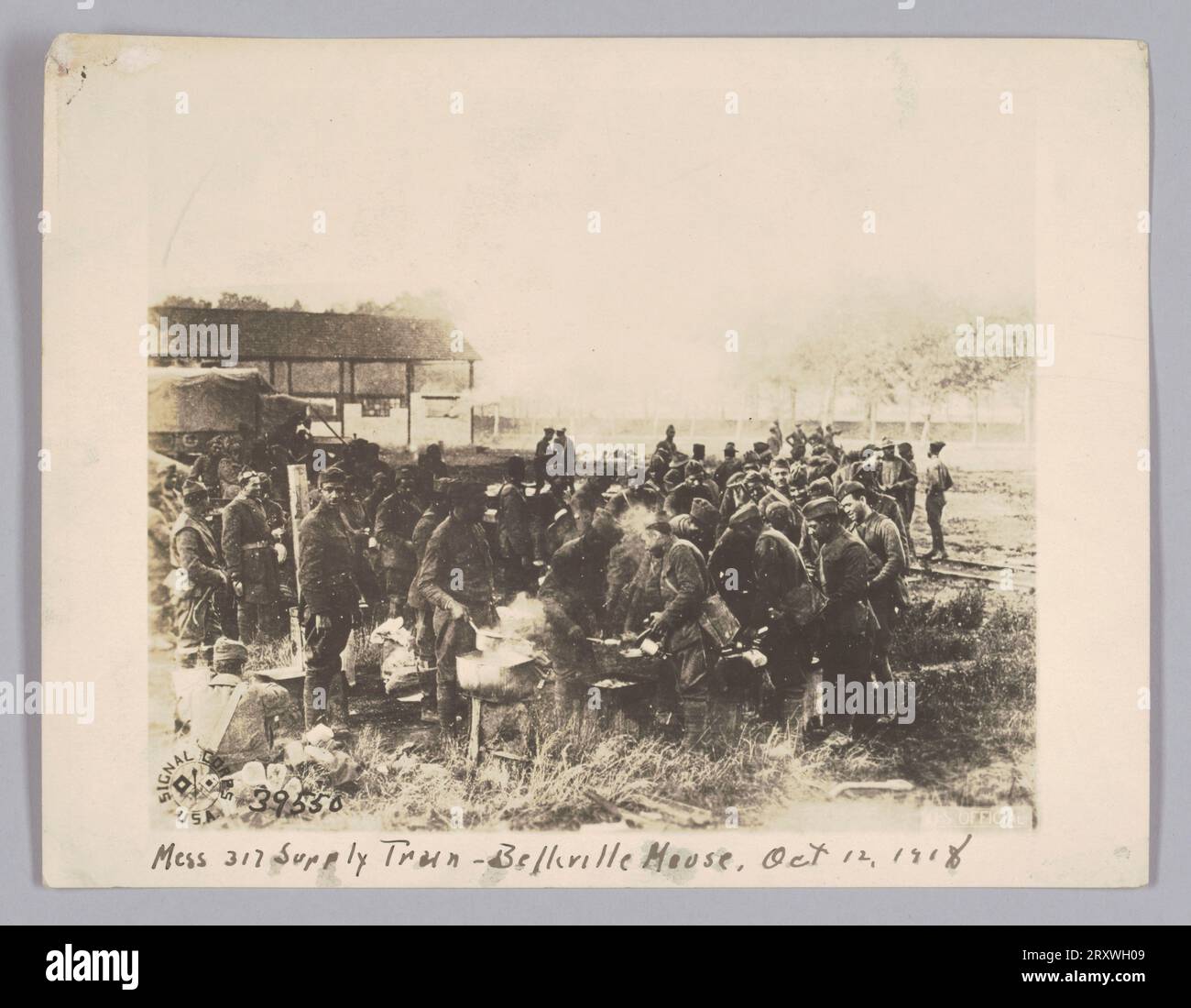 This photograph depicts the 317th Supply Train at mess. The soldiers ...