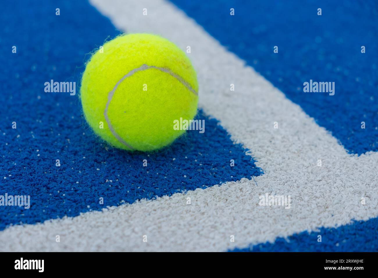 paddle tennis ball at the vertex of the lines of a blue paddle tennis ...